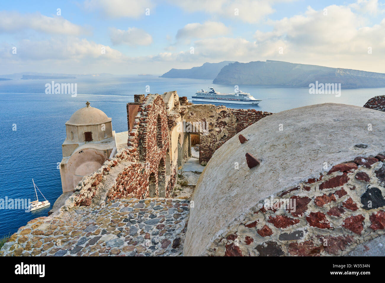 Tourists on Oia Castle wait for the sunset with Caldera View and the ...