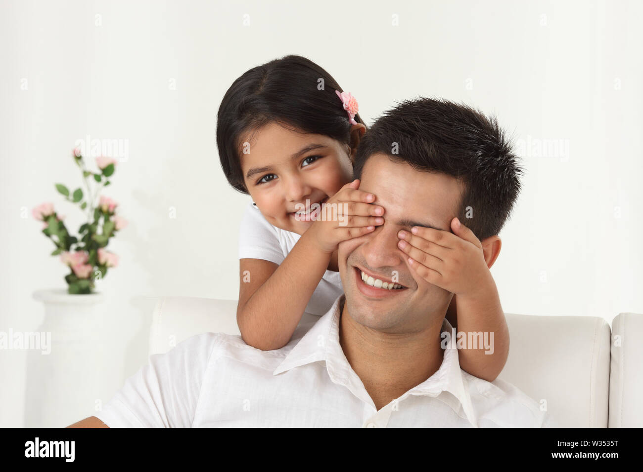 Girl covering her father eyes from behind Stock Photo - Alamy