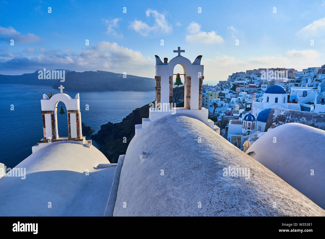 Tourists in restaurants and on Oia Castle wait for the sunset with ...