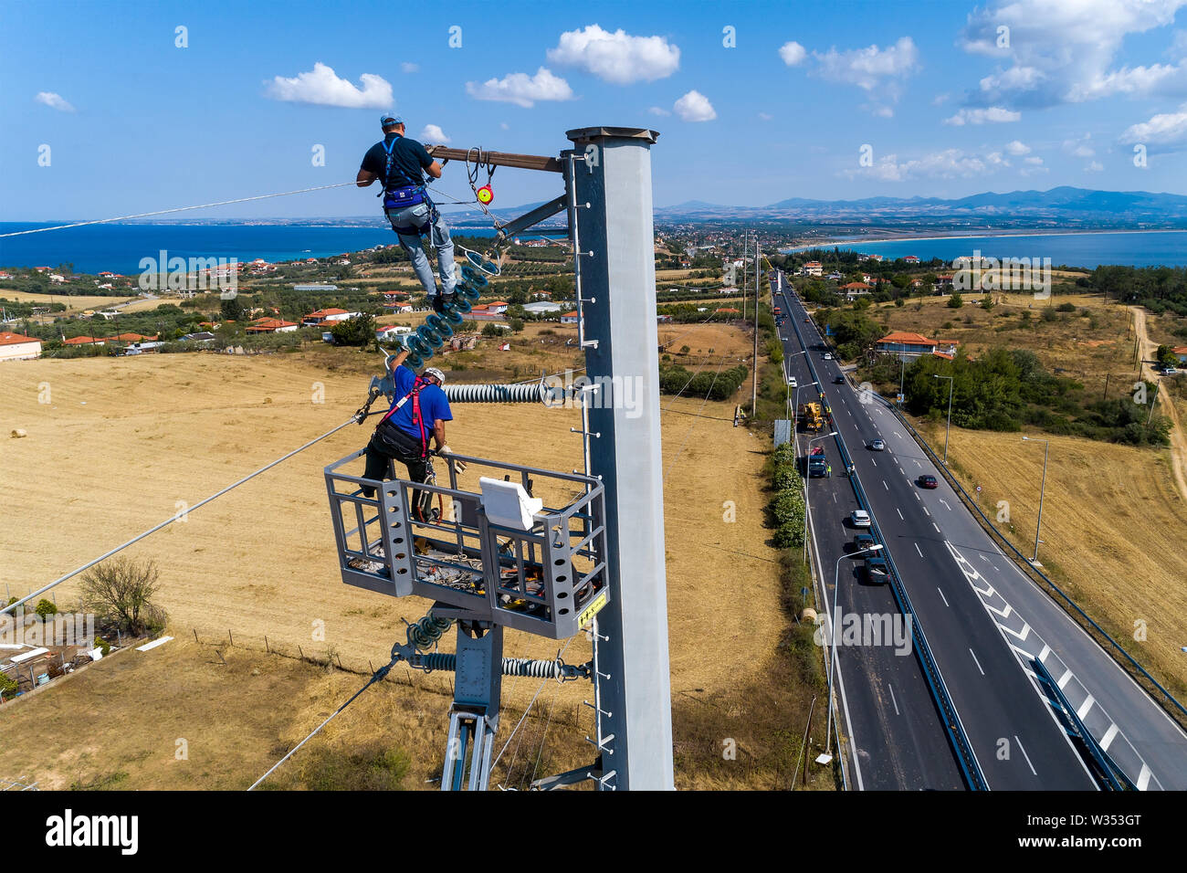 Chalkidiki, Greece - July 12, 2019: Electricians are climbing on ...
