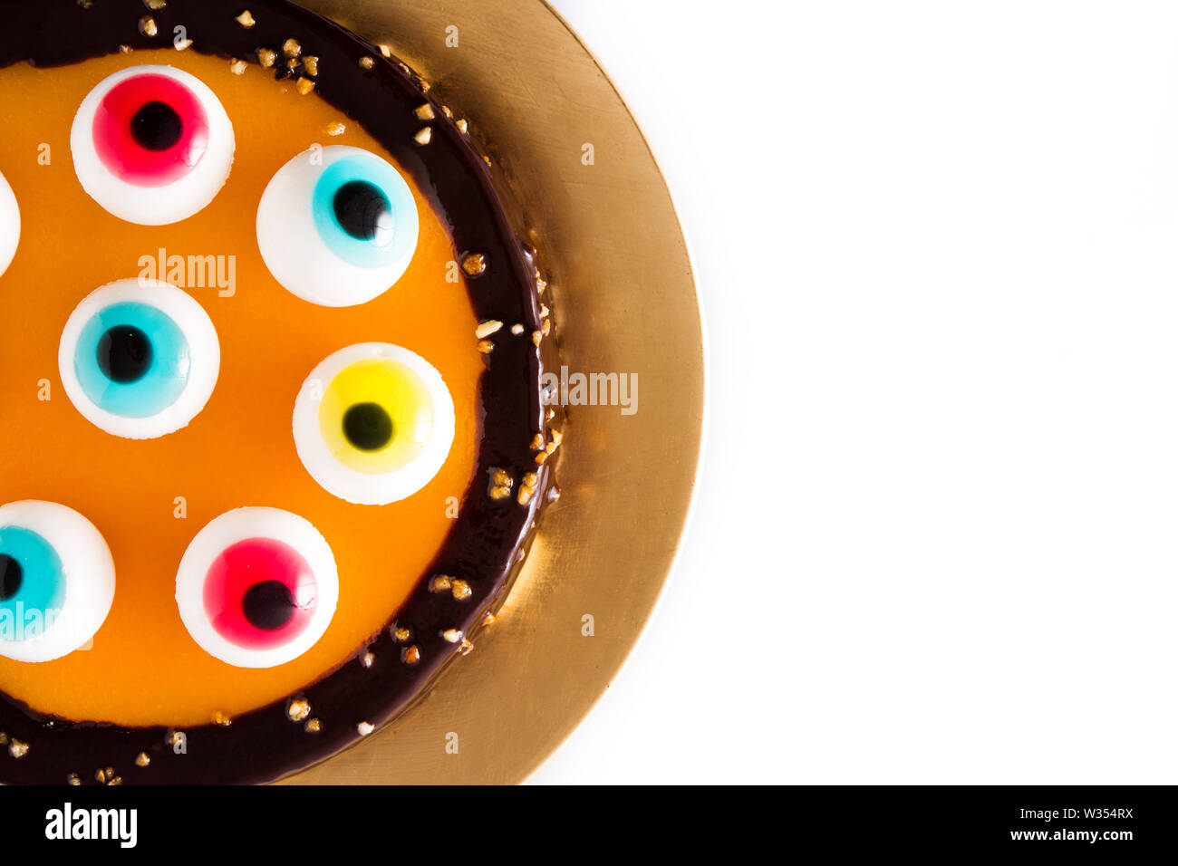 Halloween cake with candy eyes decoration isolated on white background ...