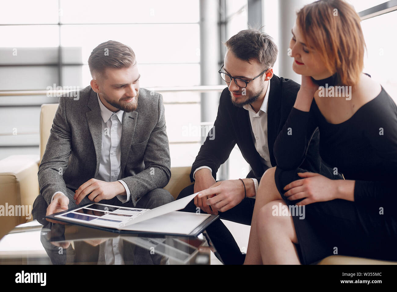 Stylish and elegant couple in a car salon Stock Photo - Alamy