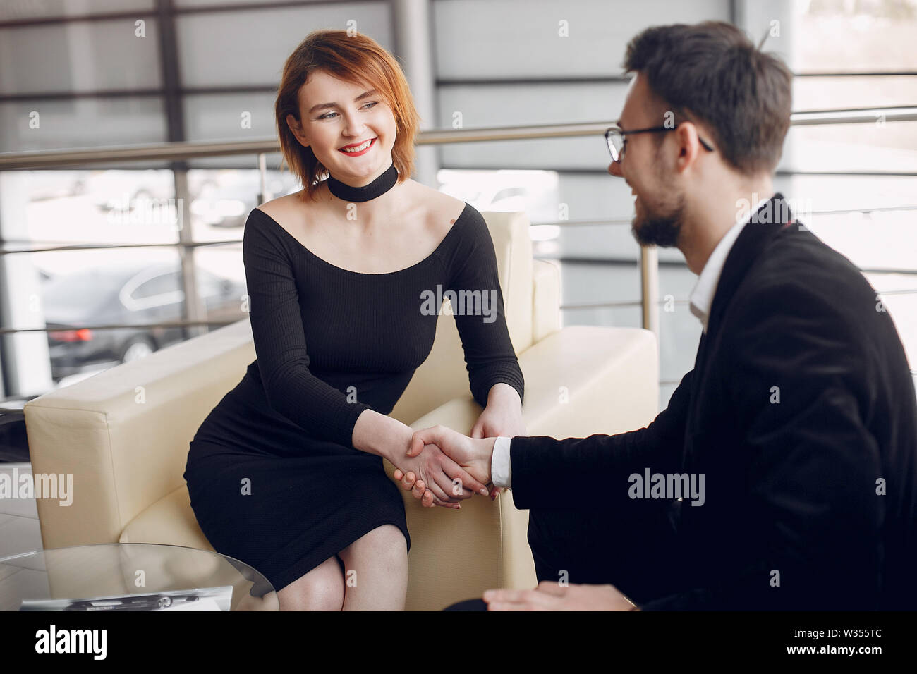 Stylish and elegant couple in a car salon Stock Photo - Alamy