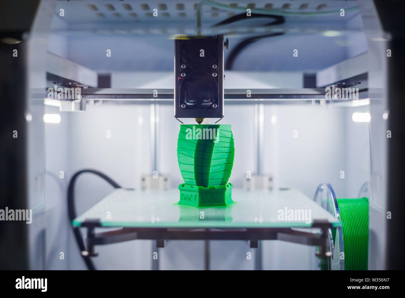 Three dimensional printing machine prints physical 3D model Stock Photo ...