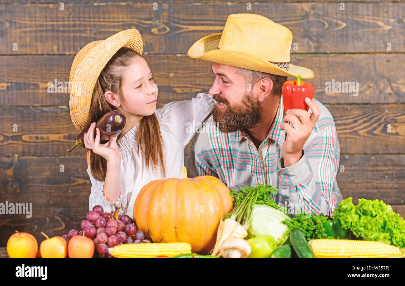 Family father farmer gardener with daughter near harvest vegetables ...