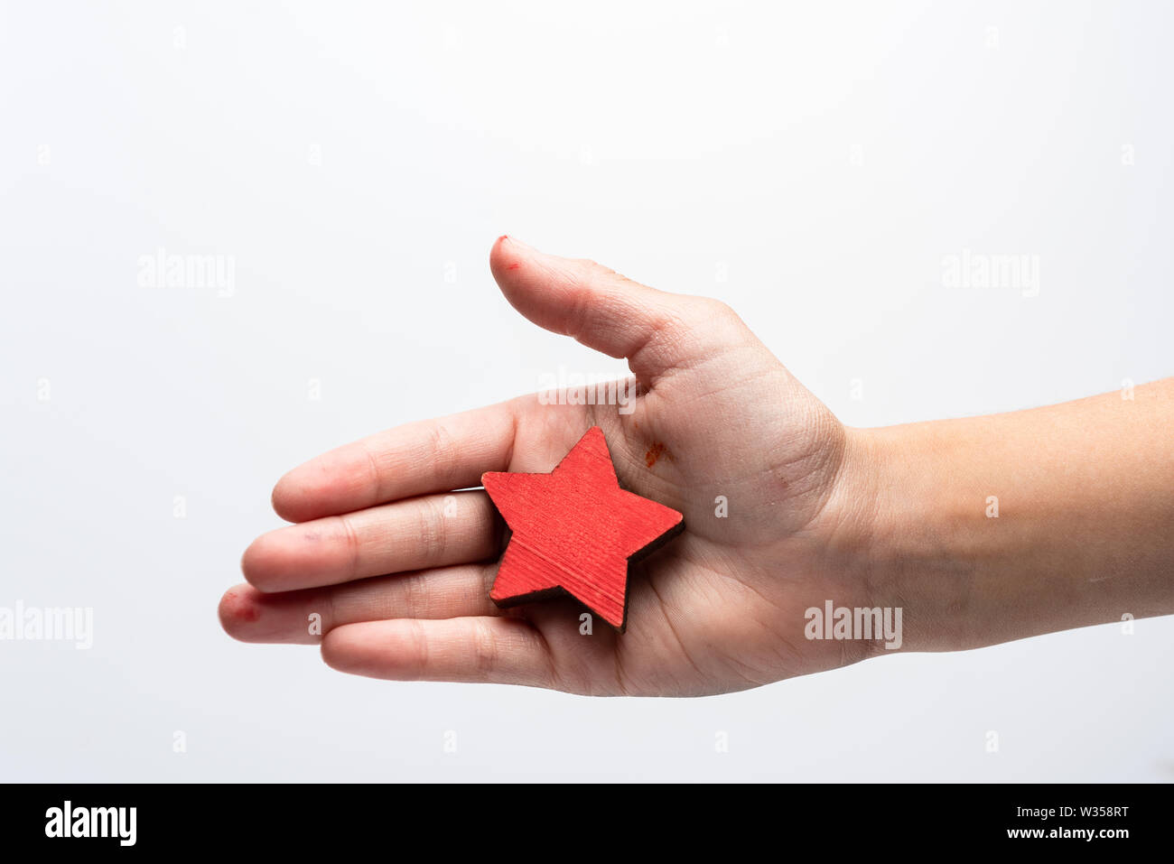 Star rating in the children's hand. Red approval sign on a white ...
