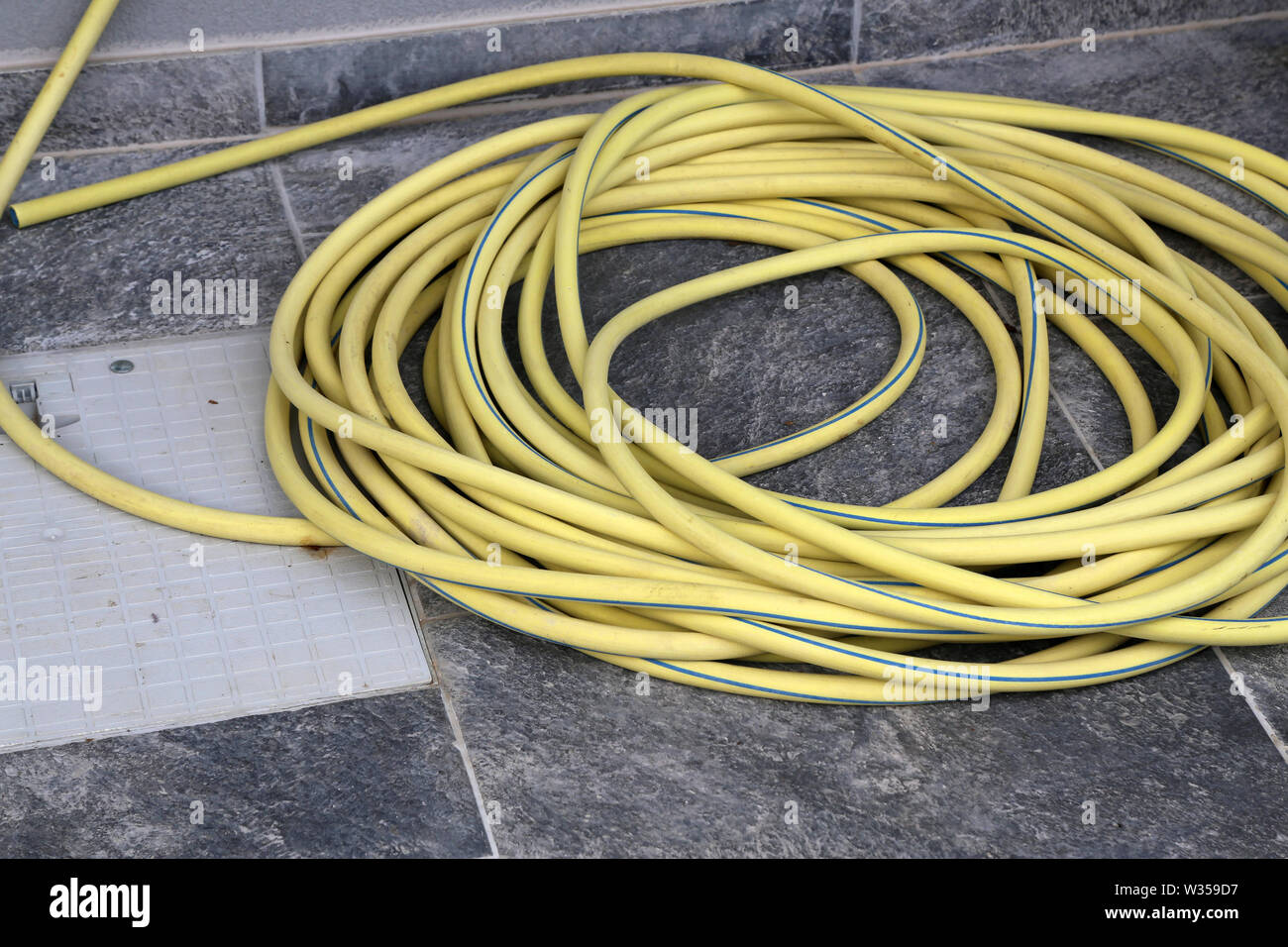 Rubber plang for watering the vegetable garden Stock Photo - Alamy