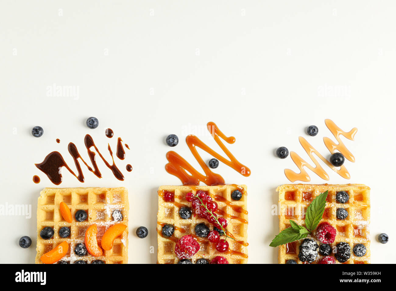 Flat lay composition with belgian waffles and different toppings, top ...