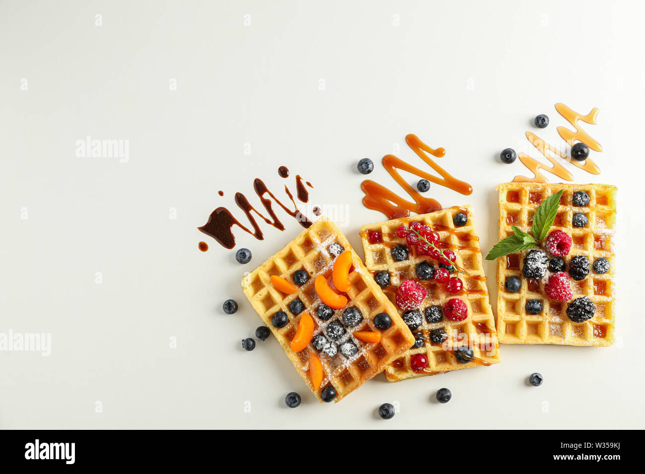 Flat lay composition with belgian waffles and different toppings, top ...