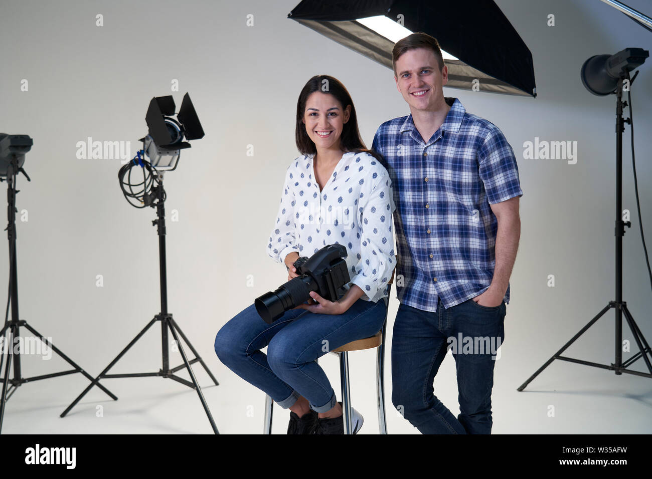 Portrait Of Female And Male Photographers In Studio For Photo Shoot ...