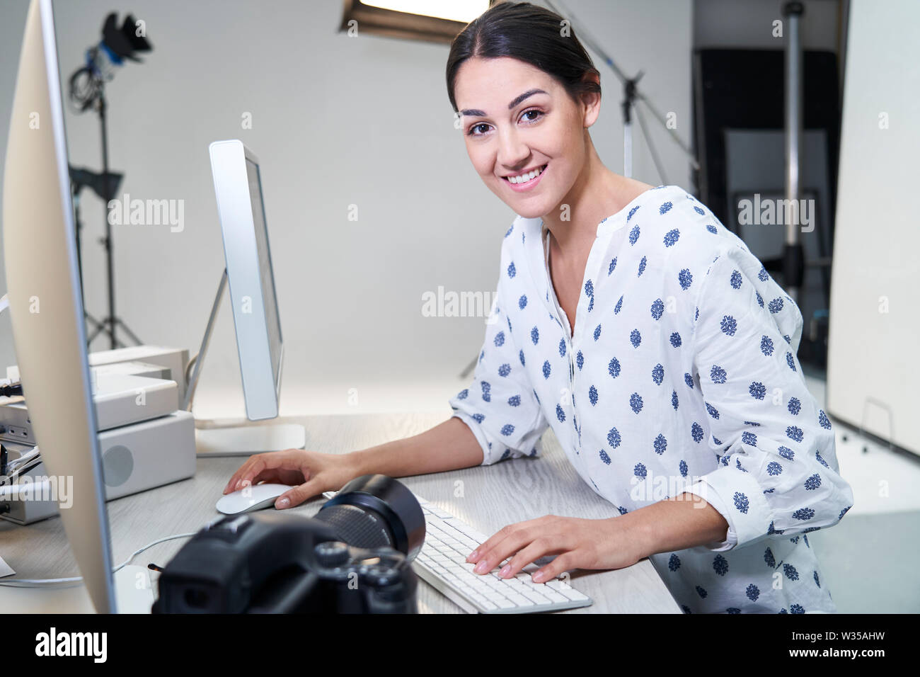 Portrait Of Female Photographer In Studio Reviewing Images From Photo ...