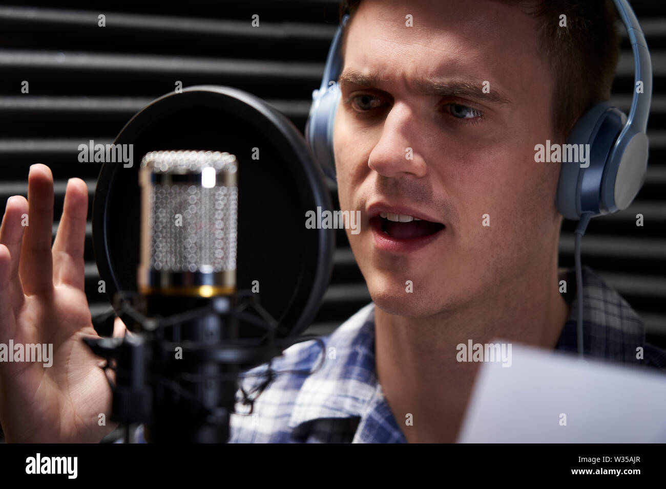 Man In Recording Studio Talking Into Microphone Stock Photo - Alamy