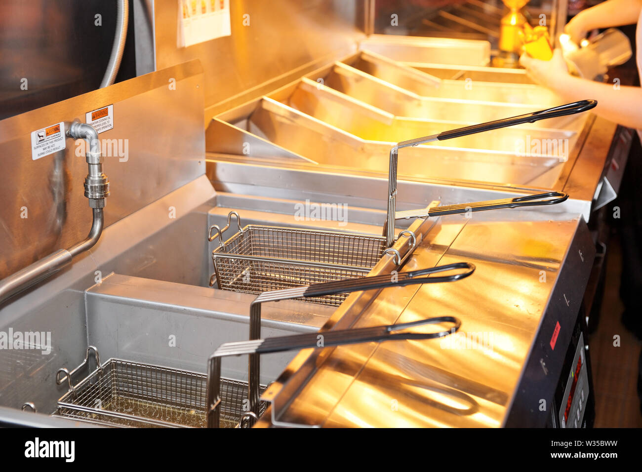 Deep fryer with boiling oil on restaurant kitchen Stock Photo - Alamy