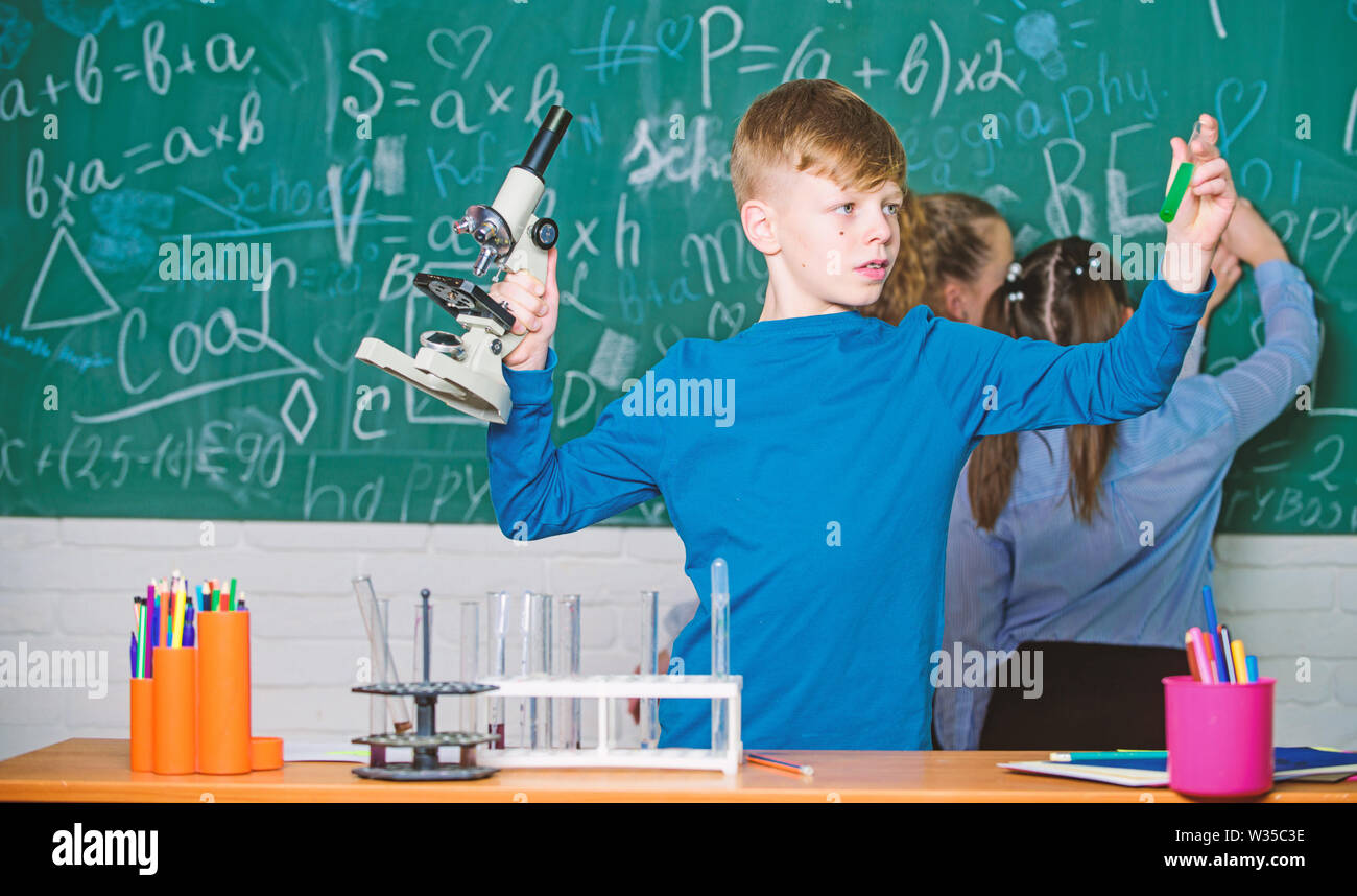 students doing biology experiments with microscope in lab. Happy ...