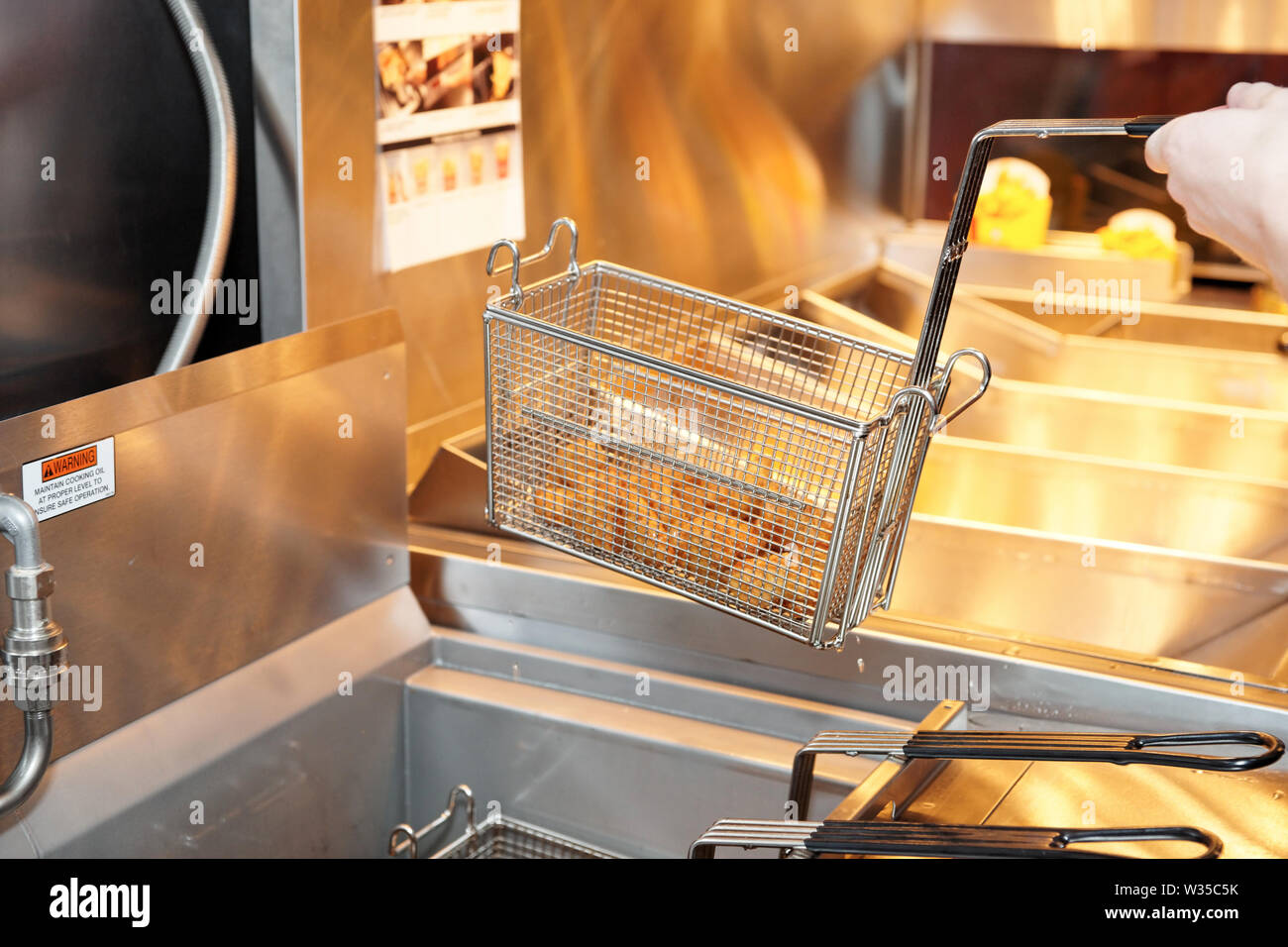 Deep fryer with boiling oil on restaurant kitchen Stock Photo - Alamy