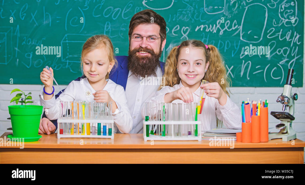 Moving science forward. Little girls scientists holding test tubes at ...