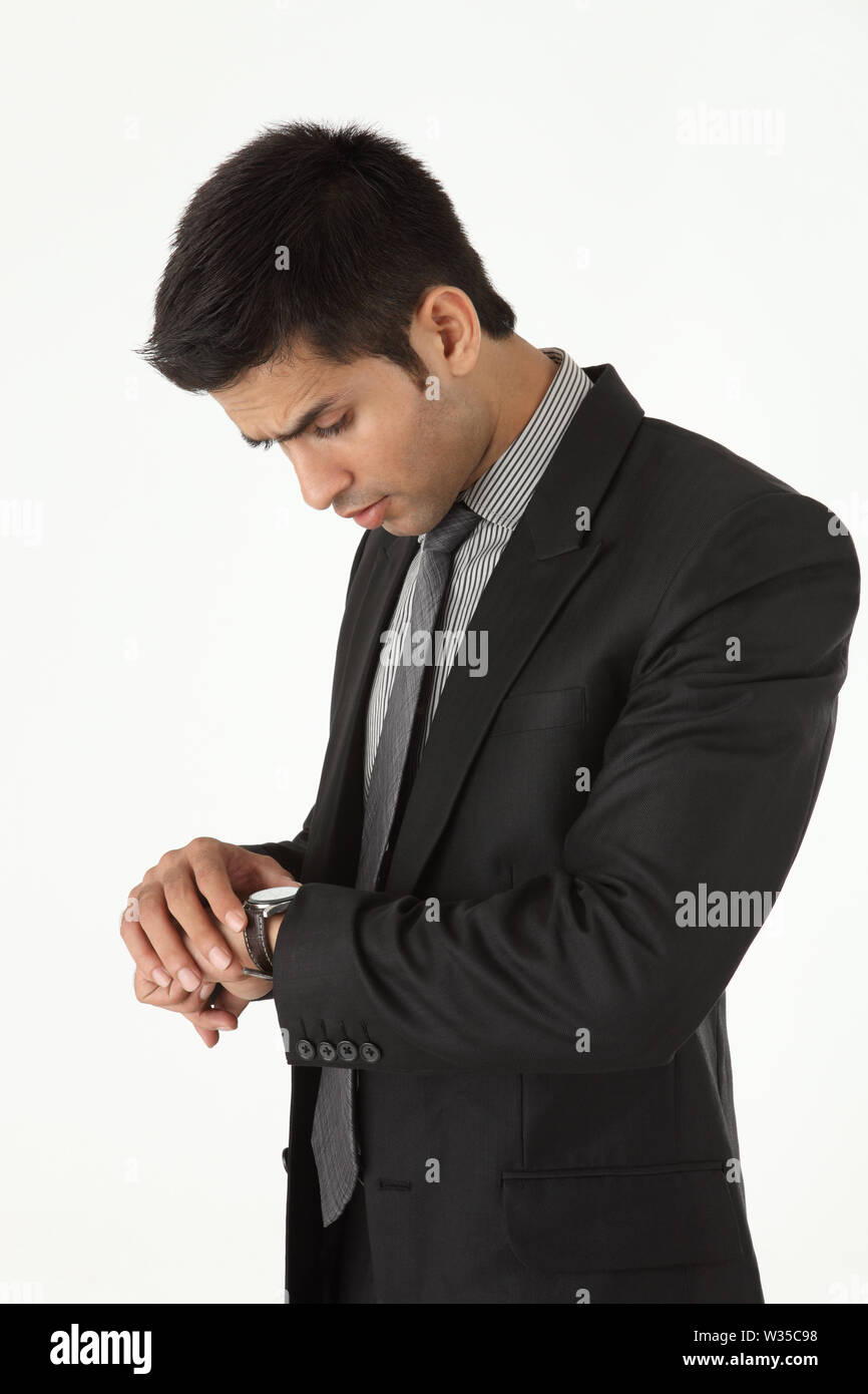 Indian businessman checking the time Stock Photo - Alamy