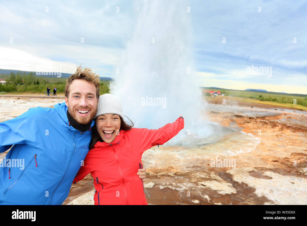 Iceland tourists fun by Strokkur geyser happy visiting famous tourist ...
