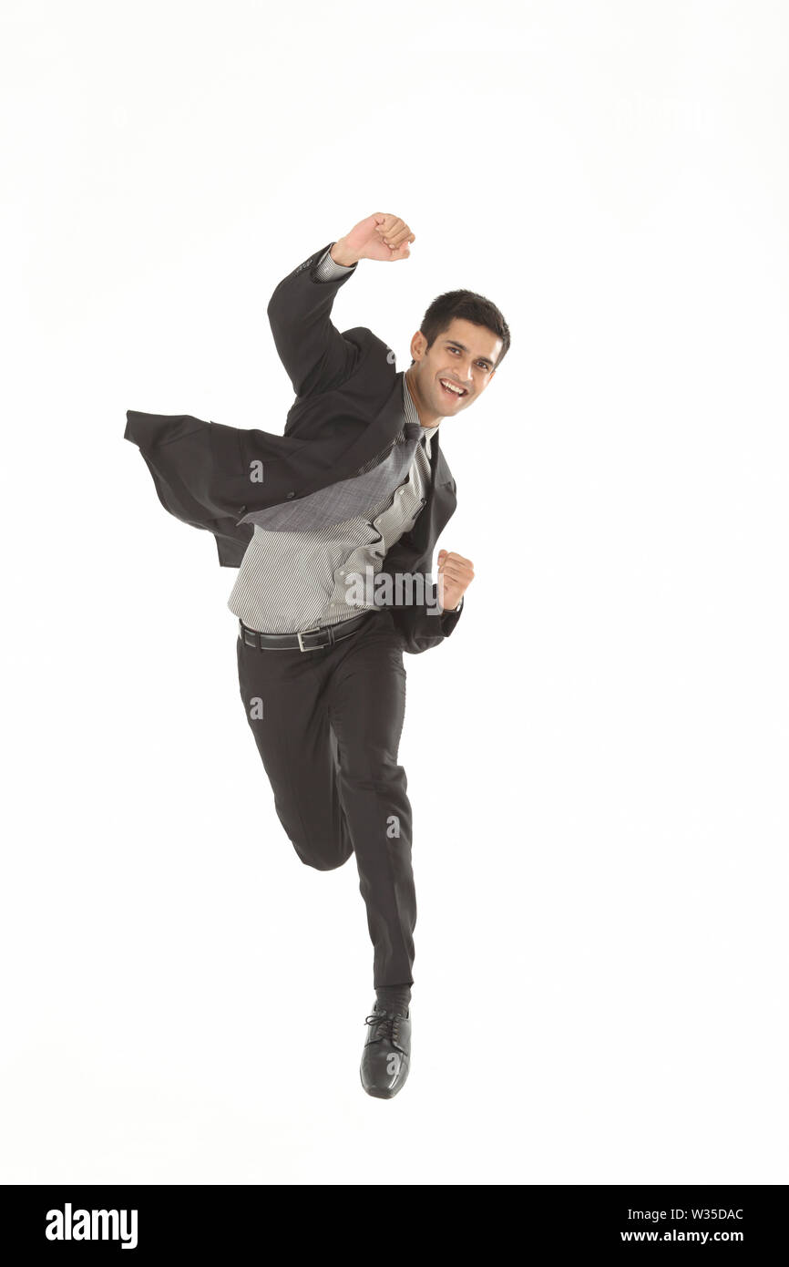 Portrait of a businessman running and smiling Stock Photo - Alamy