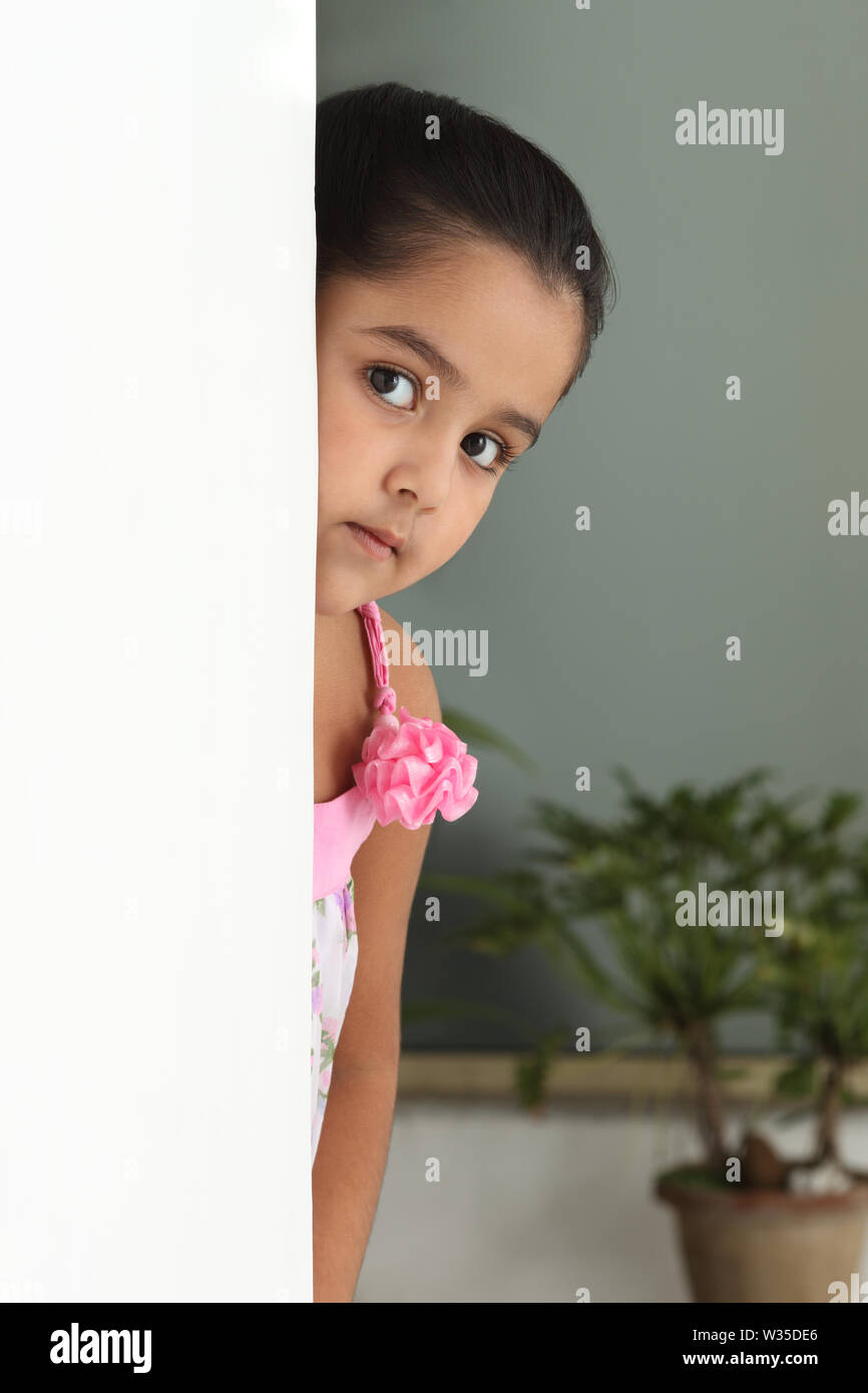Portrait indian girl hiding behind hi-res stock photography and images ...