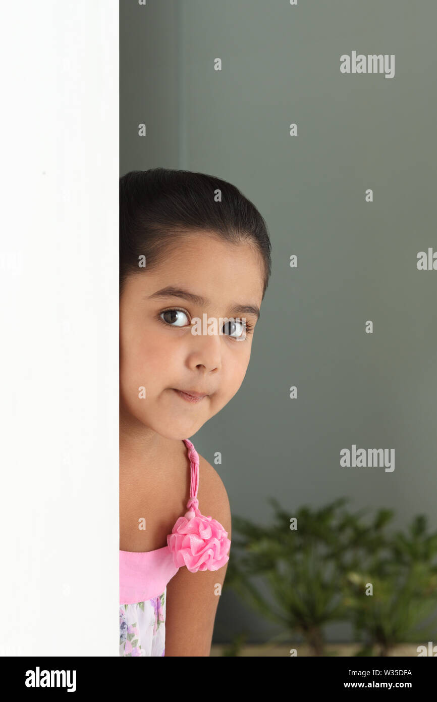 Portrait indian girl hiding behind hi-res stock photography and images ...