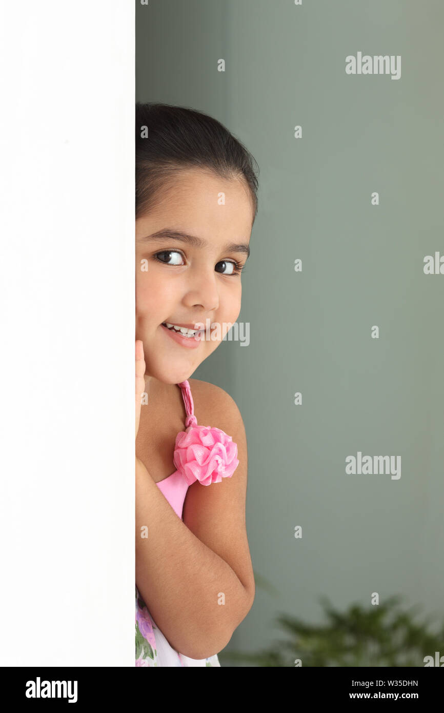 Portrait indian girl hiding behind hi-res stock photography and images ...