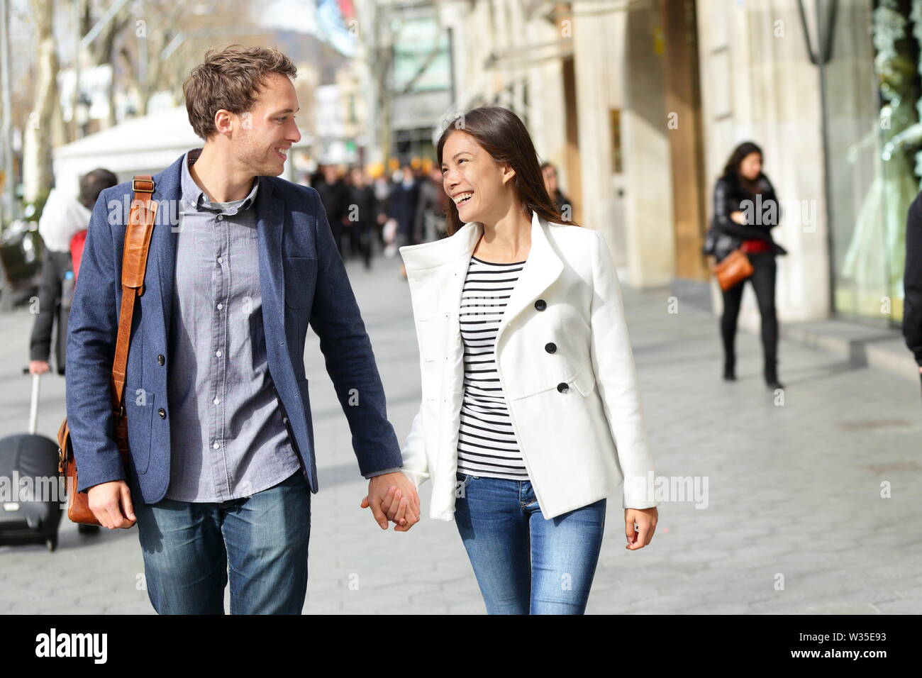 Urban modern professionals couple walking romantic laughing talking ...