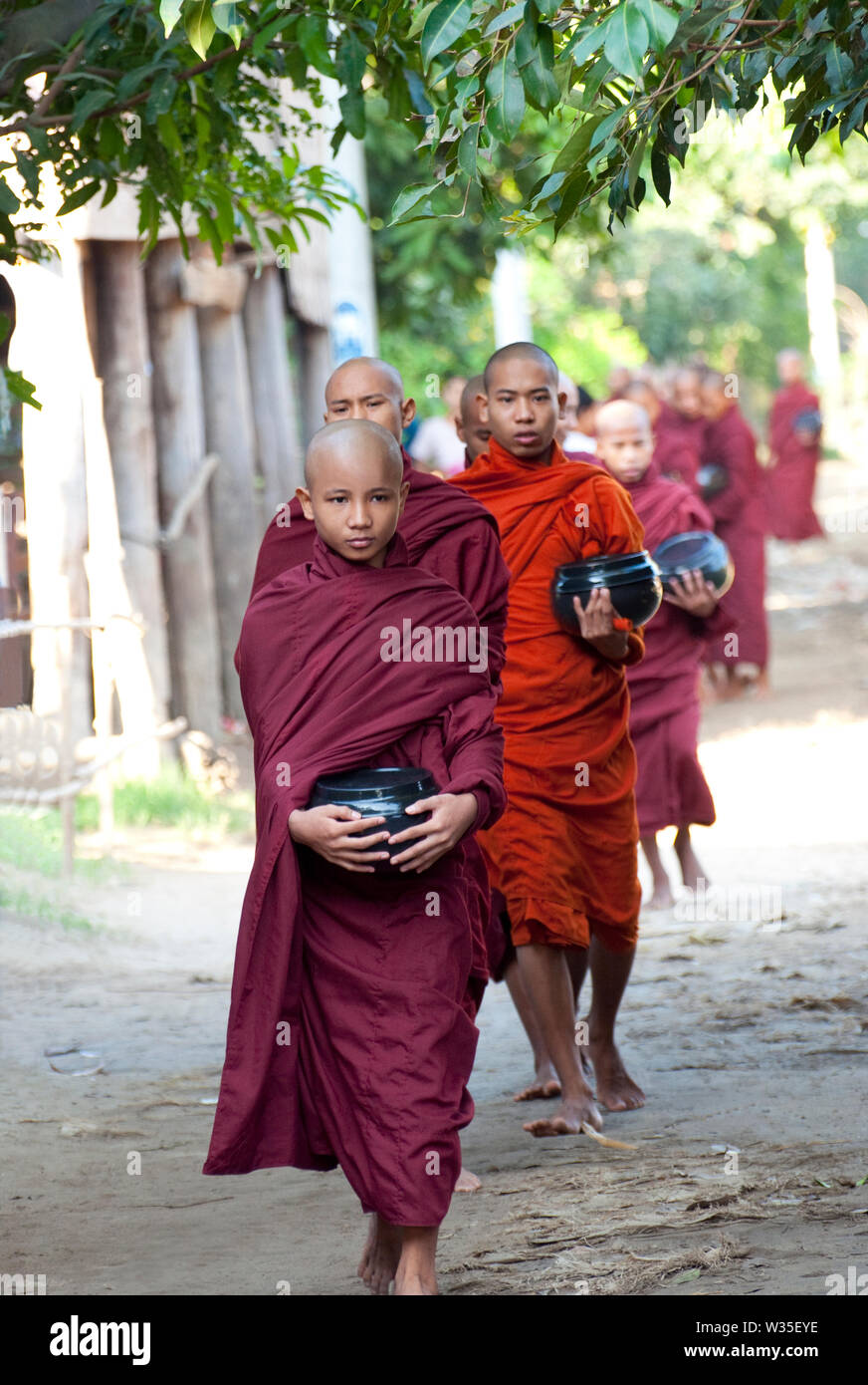 Young Buddhist Monks with Their Alms Bowls Walking Through a Village ...
