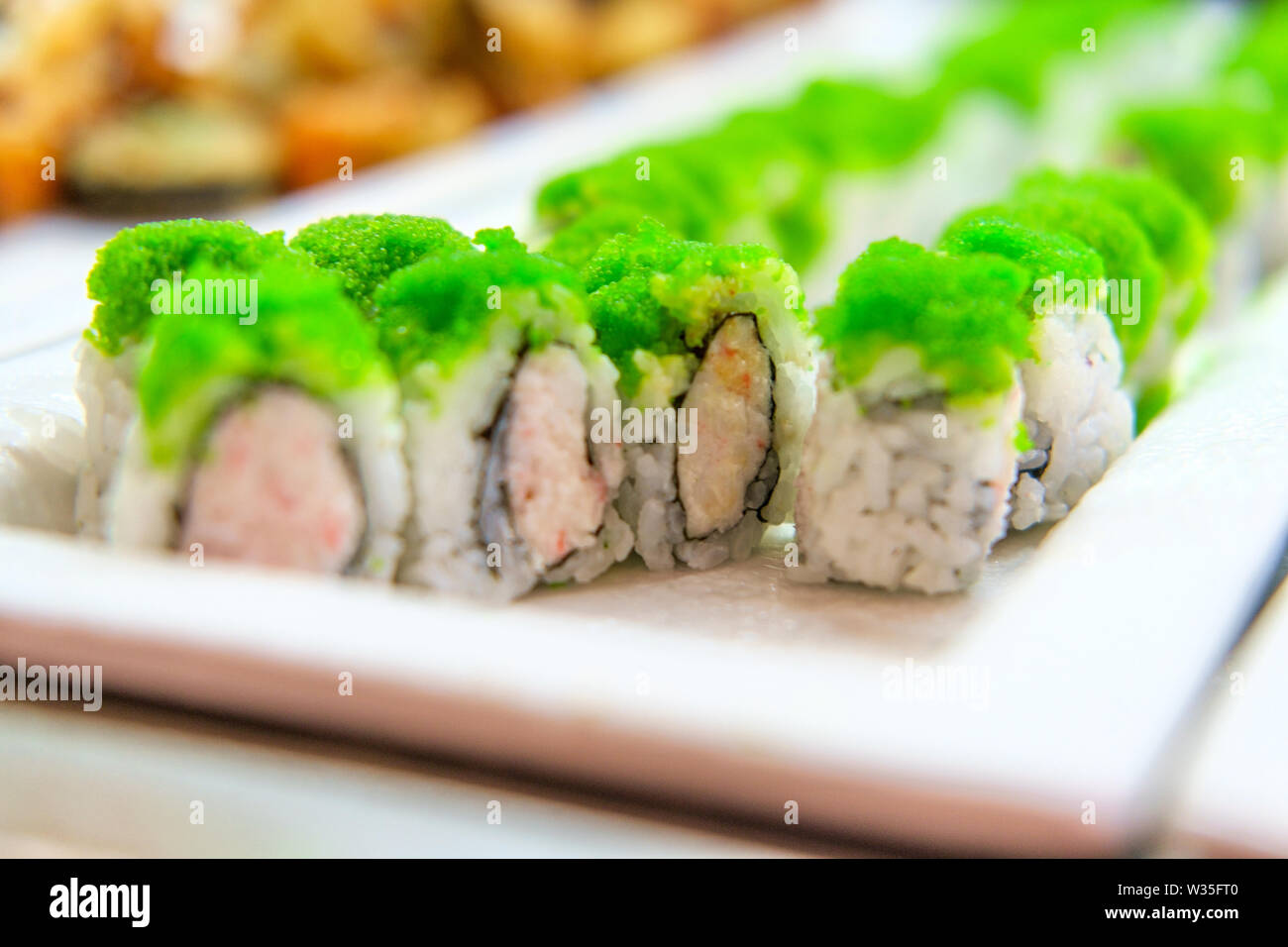 Various sushi buffet rolls at self serve station Stock Photo - Alamy