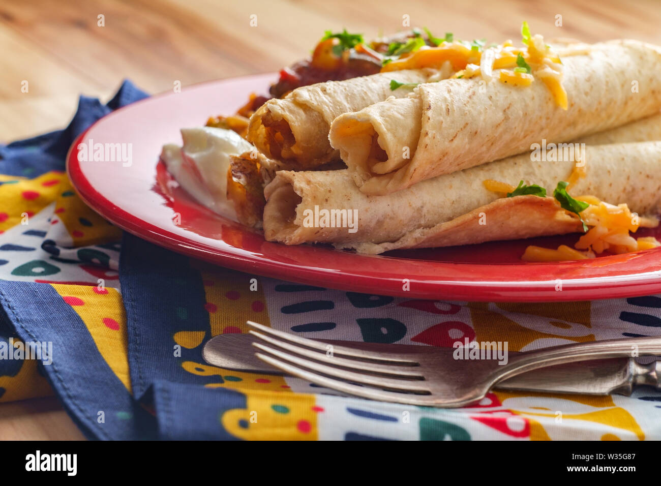 Mexican chicken and cheese taquitos with Santa Fe rice Stock Photo - Alamy