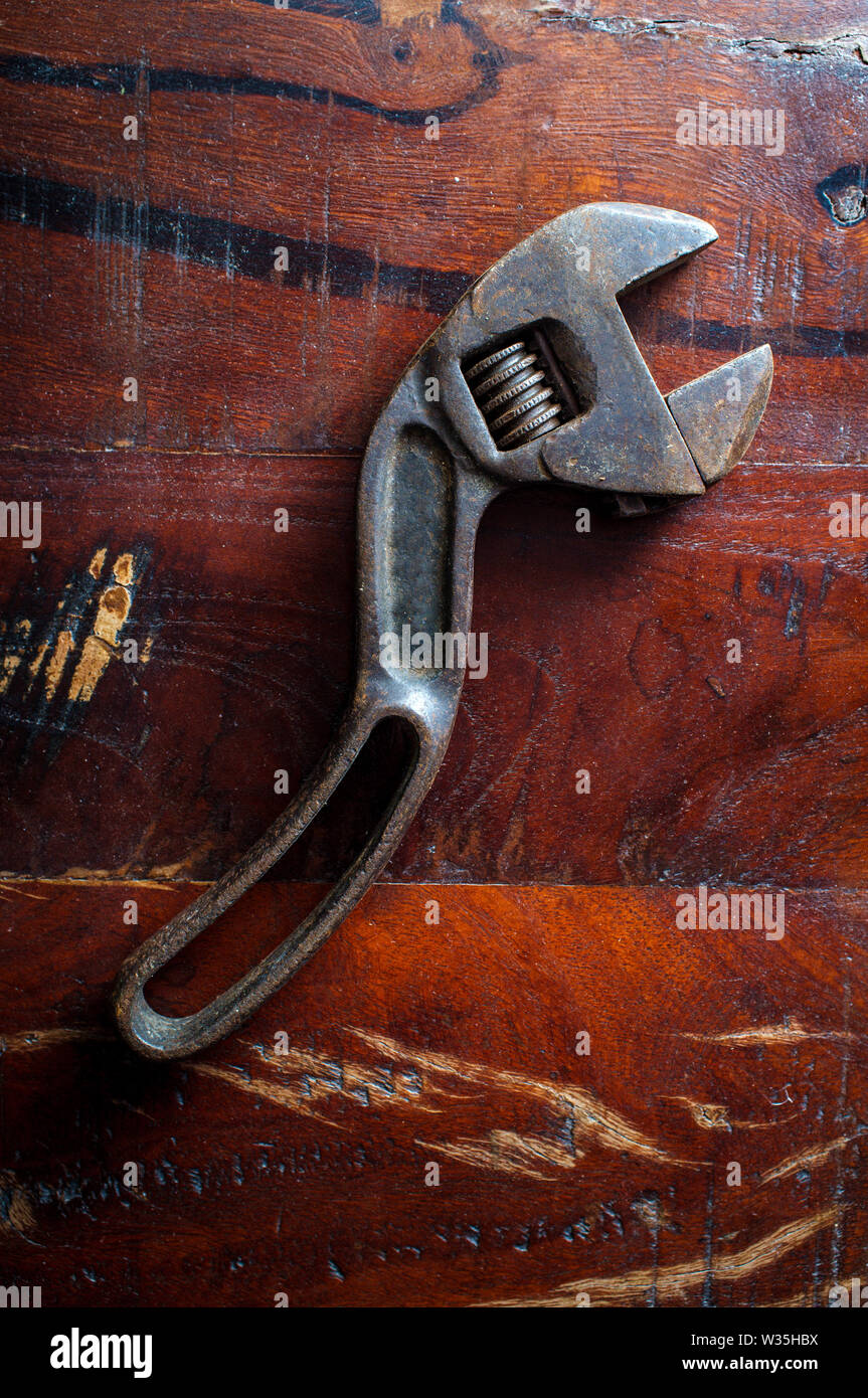 Old rusty adjustable wrench contractors tool on worn wooden floor Stock ...