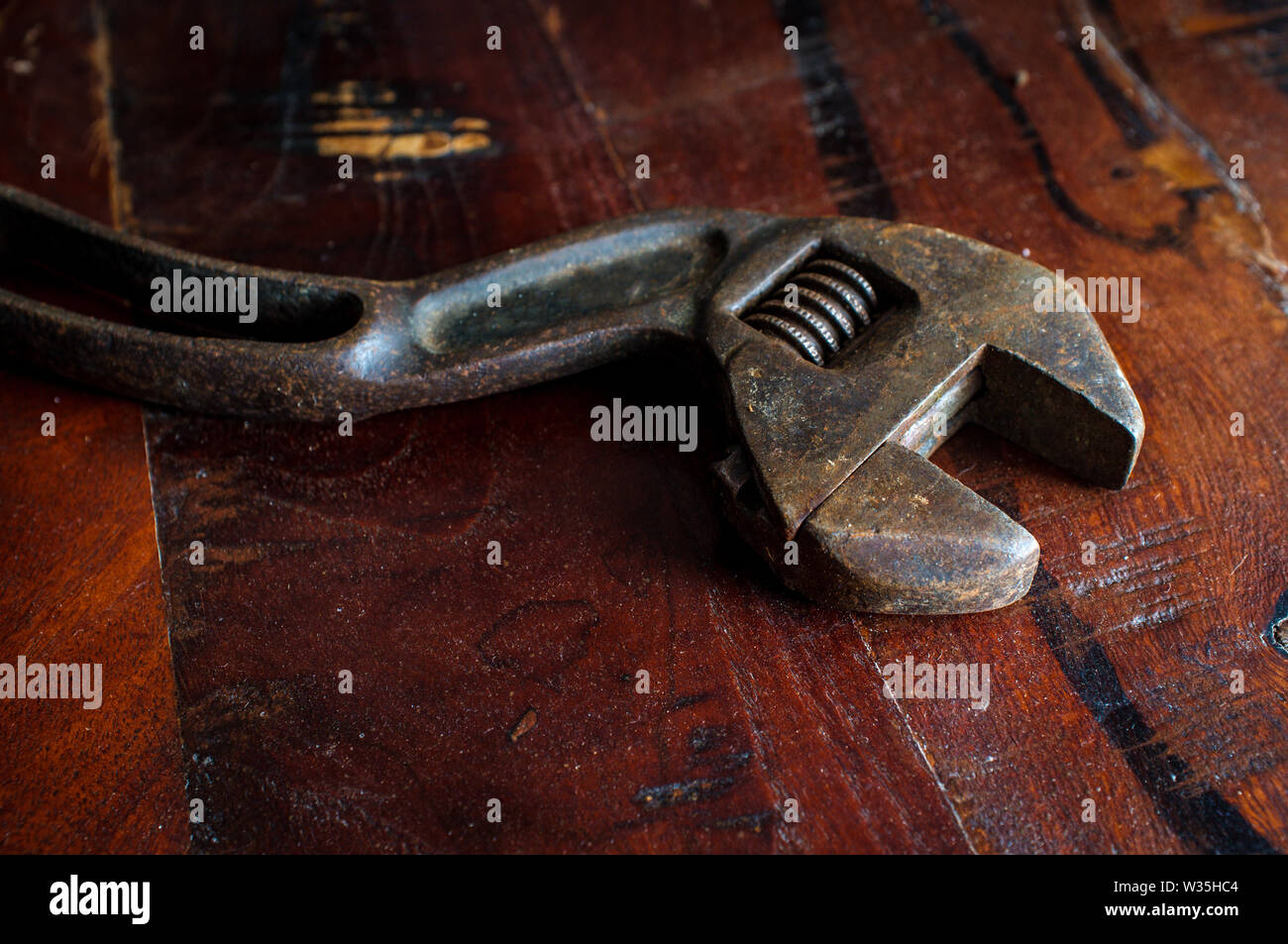 Old rusty adjustable wrench contractors tool on worn wooden floor Stock ...