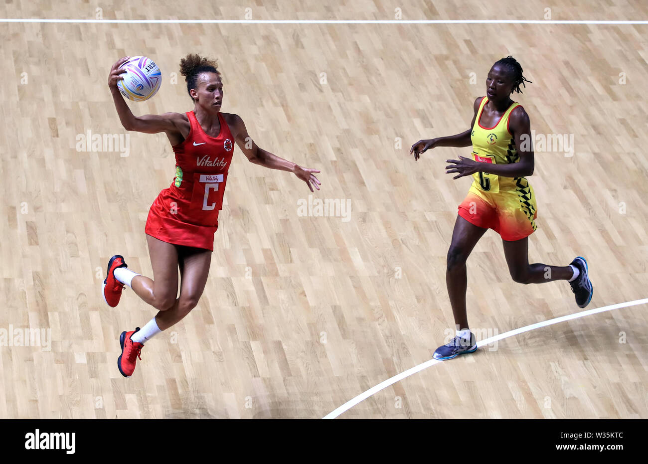 England's Serena Guthrie (left) and Uganda's Ruth Meeme battle for the ...