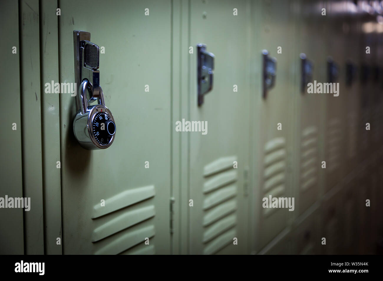 A group of green school lockers with a padlock Stock Photo - Alamy