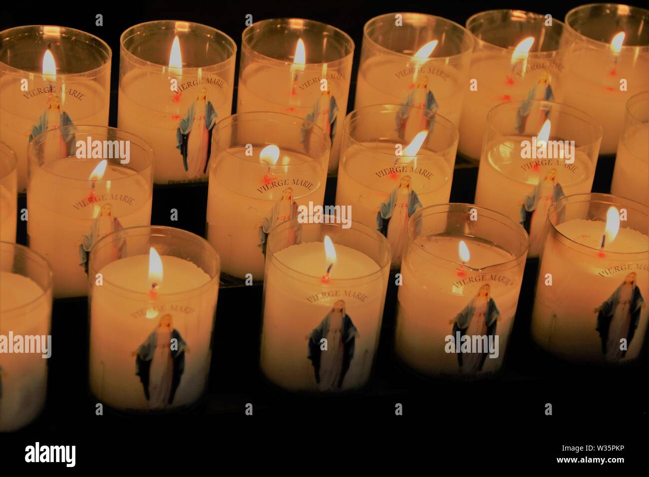 candles burning with a holy image Stock Photo - Alamy