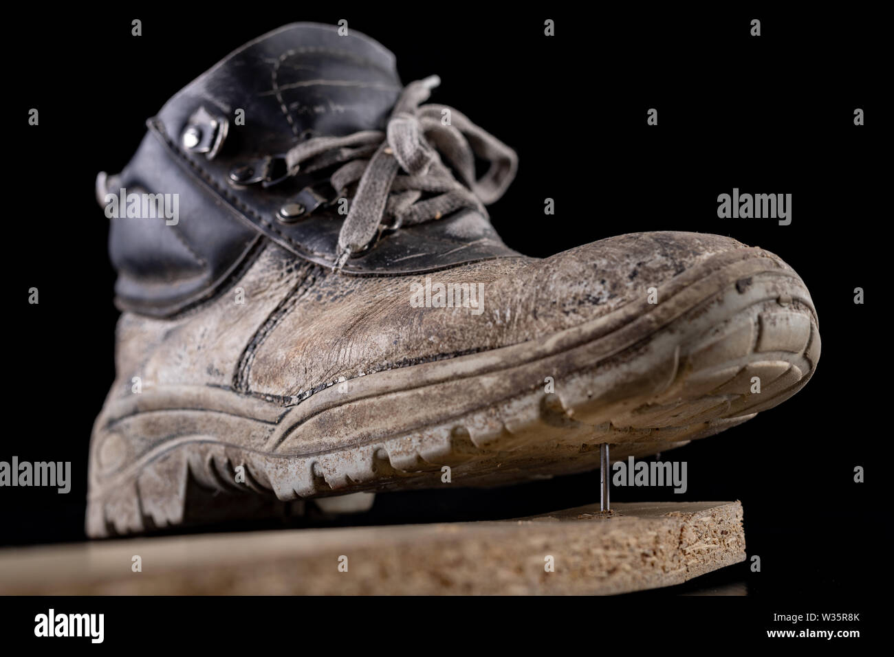 Work shoe pierced with a steel nail. Working clothes during a work ...
