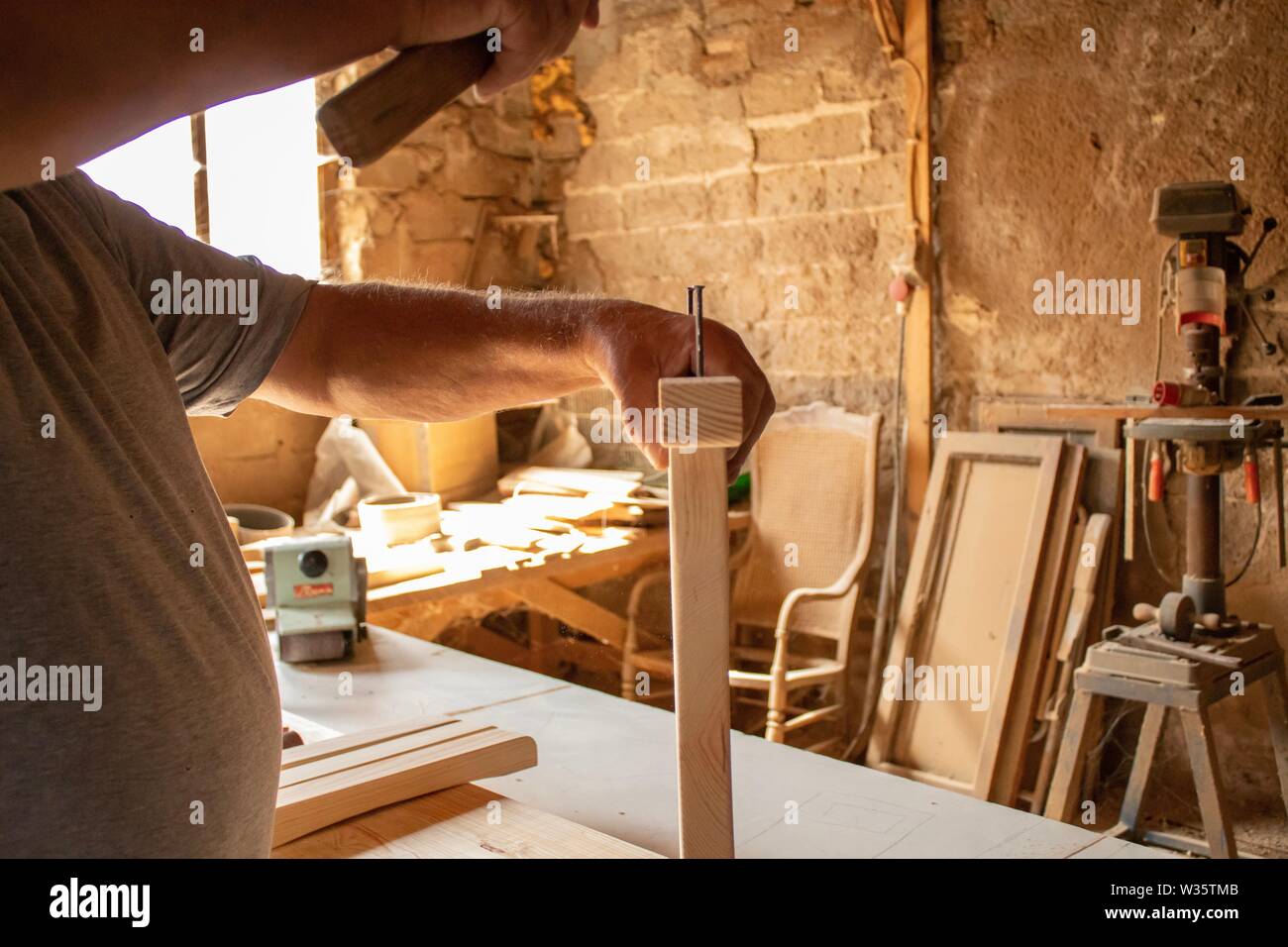 Carpenter working. Hands doing woodwork with natural light. Woodworking ...