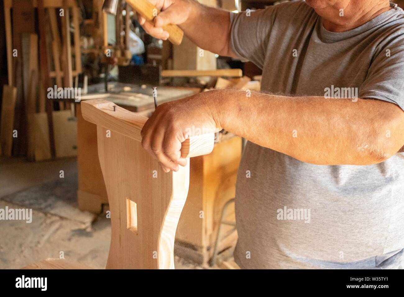 Carpenter working. Hands doing woodwork with natural light. Woodworking ...