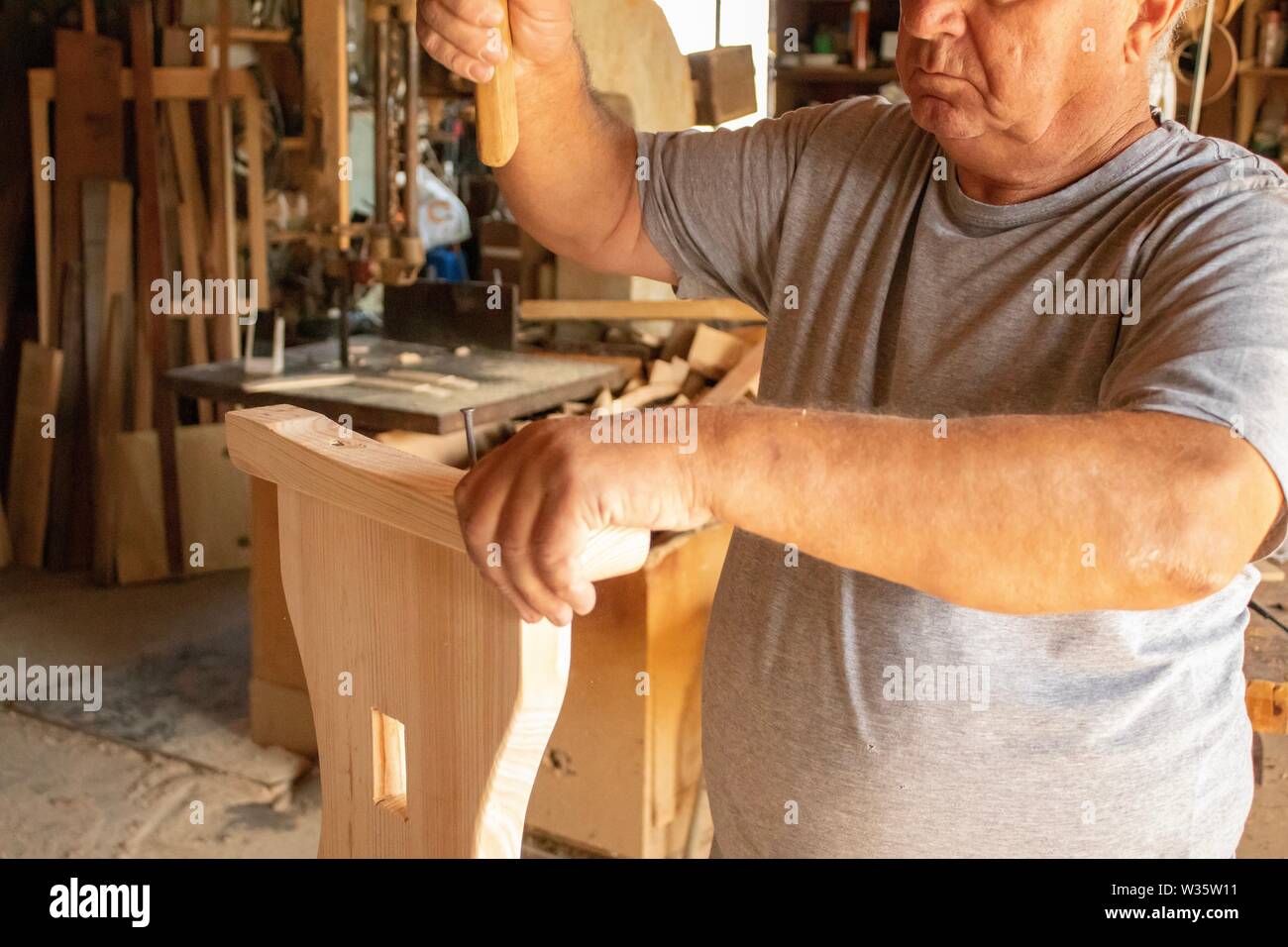 Carpenter working. Hands doing woodwork with natural light. Woodworking ...