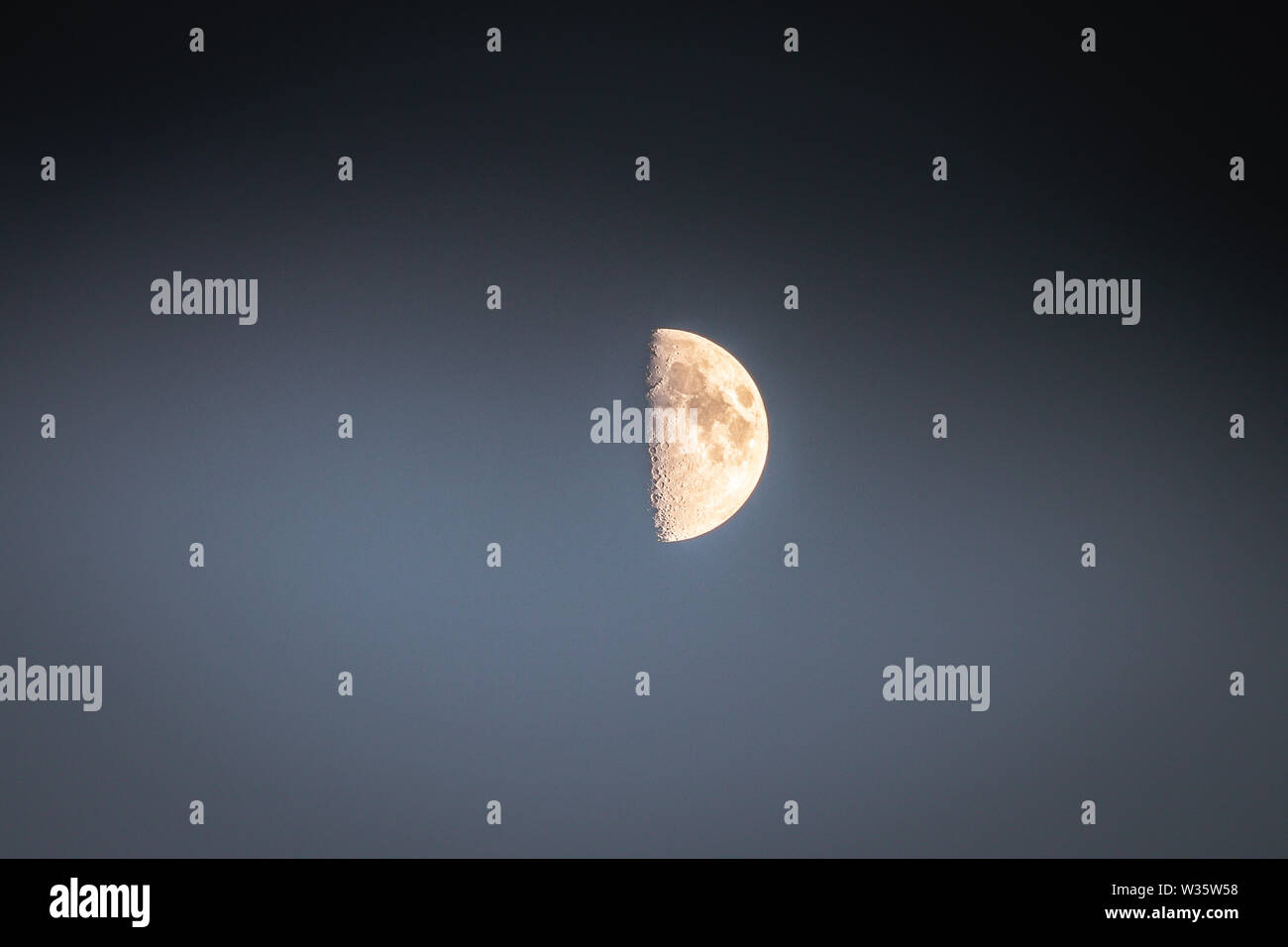 Half moon with gradient gray sky in the background Stock Photo - Alamy