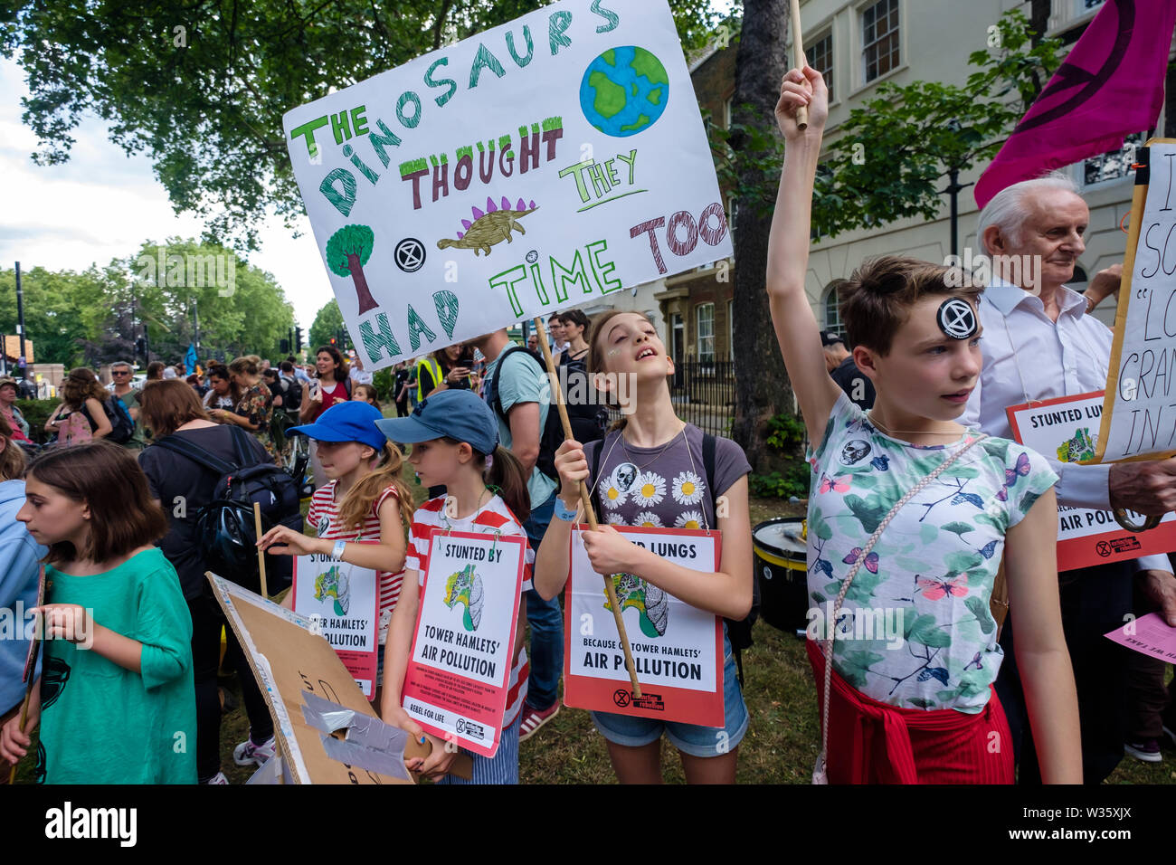 London, UK. 12th July 2019. Children with posters about air pollution ...