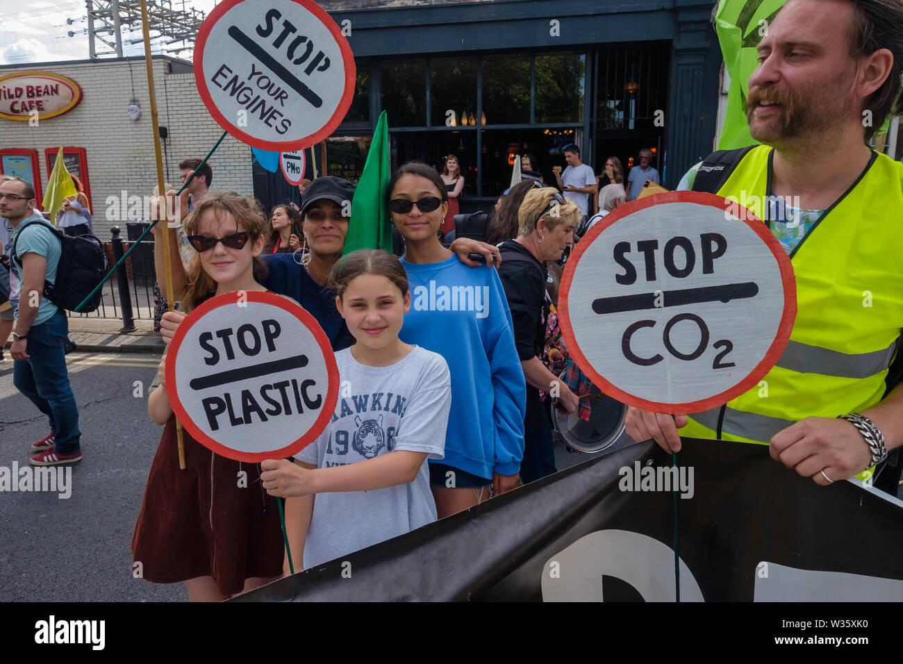 London, UK. 12th July 2019. People with 'Stop' signs at a brief halt on ...