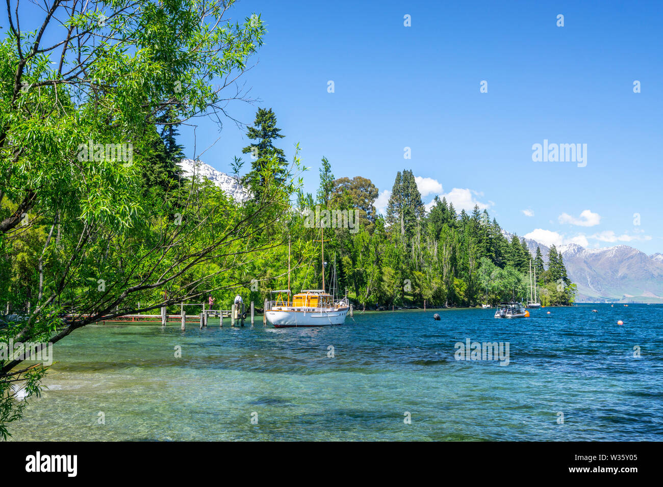 Wooden boat at jetty on Lake Wanaka, Queenstown, South Island, New ...