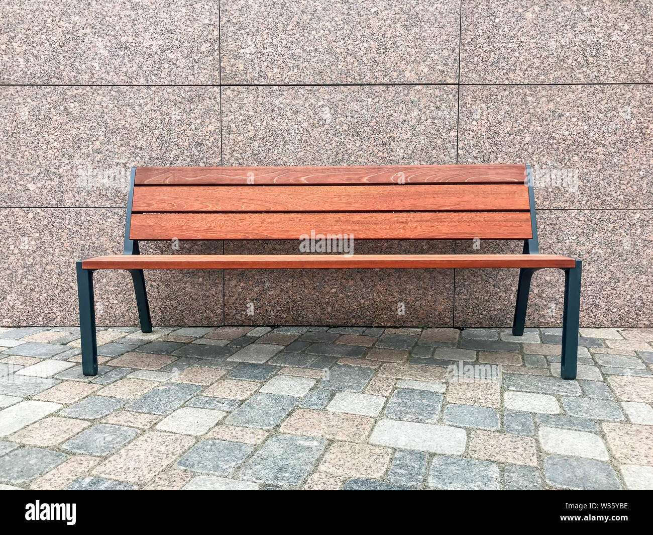 Wooden bench on street on pavement. Studio Photo Stock Photo - Alamy