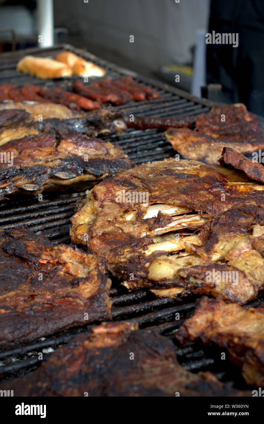Traditional argentinian "asado" (barbecue). Large pieces of meat and ...