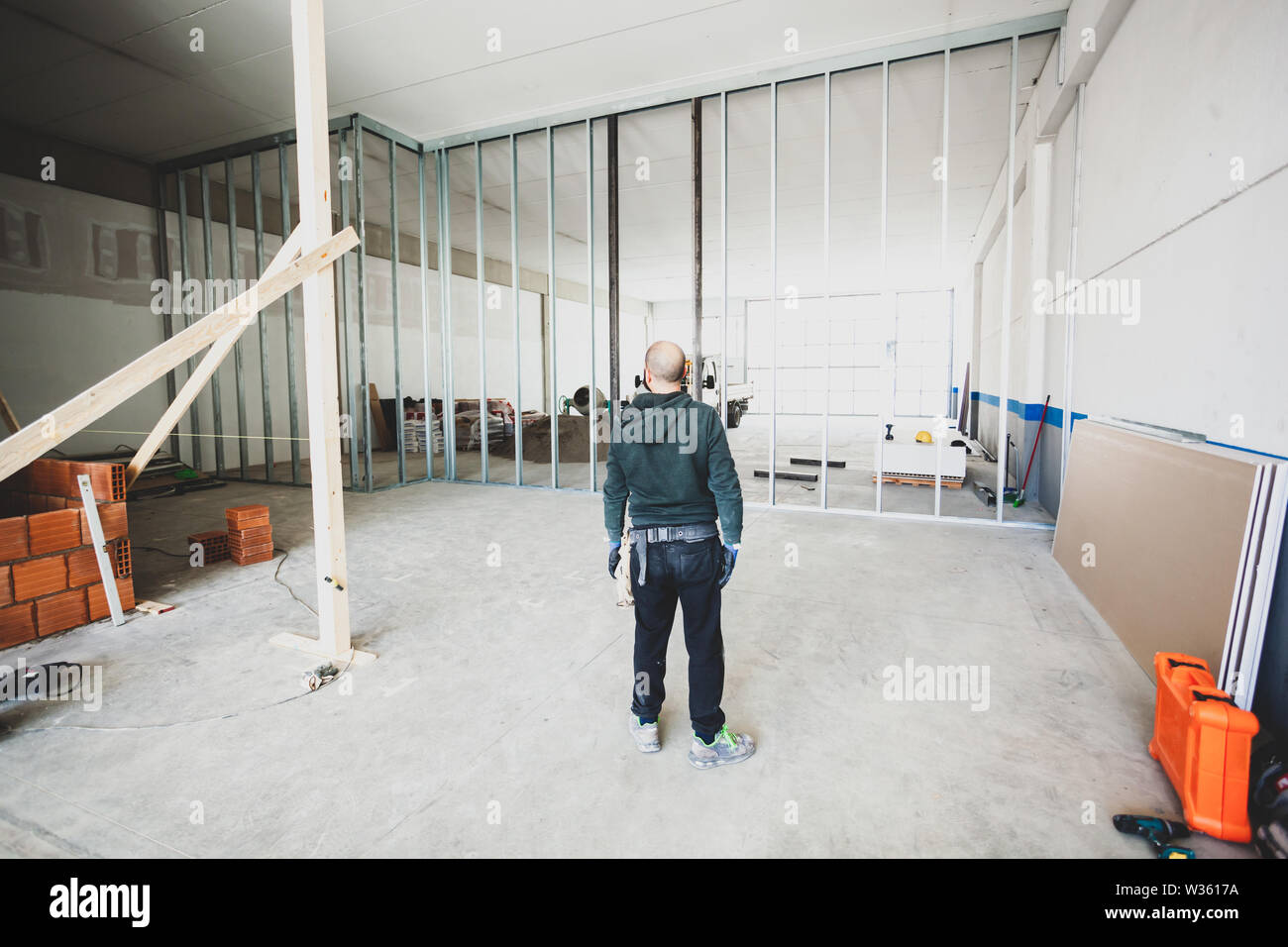 Worker at work in the construction of a plasterboard wall Stock Photo ...