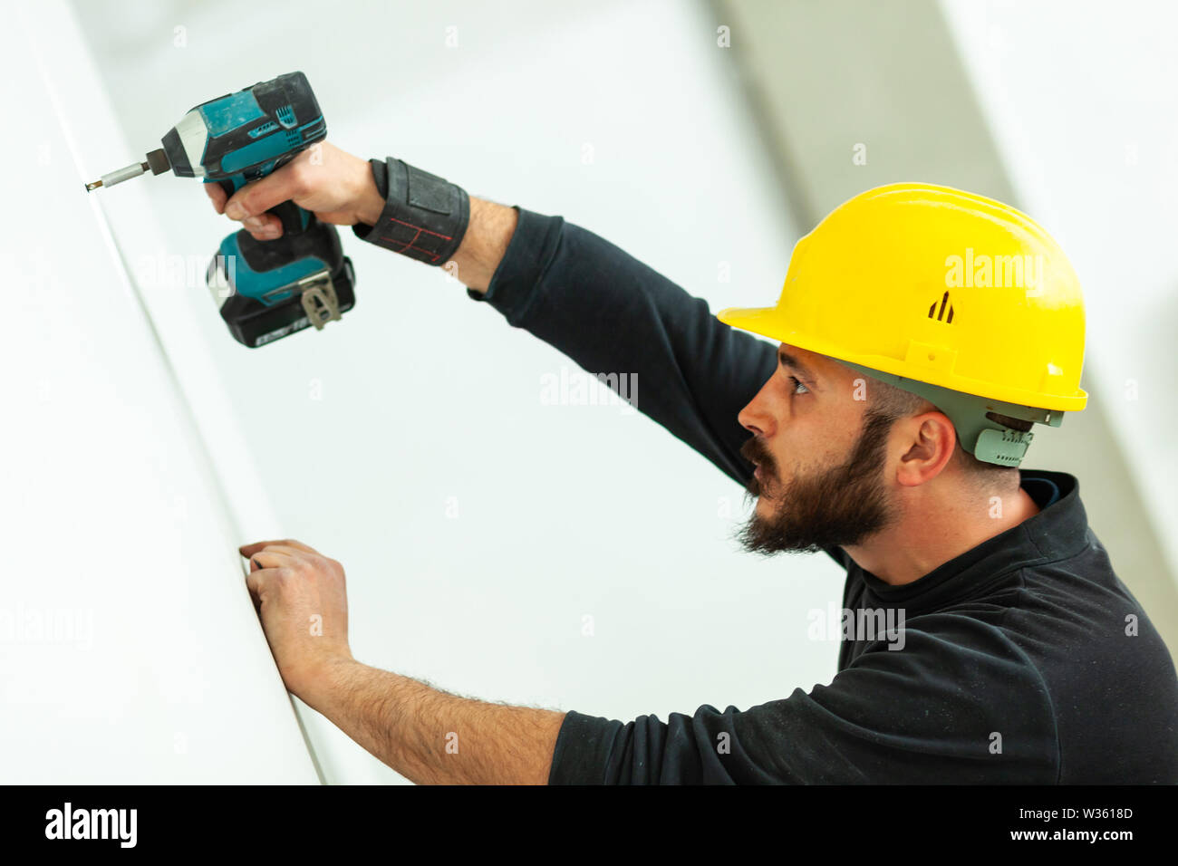 Worker at work in the construction of a plasterboard wall Stock Photo ...