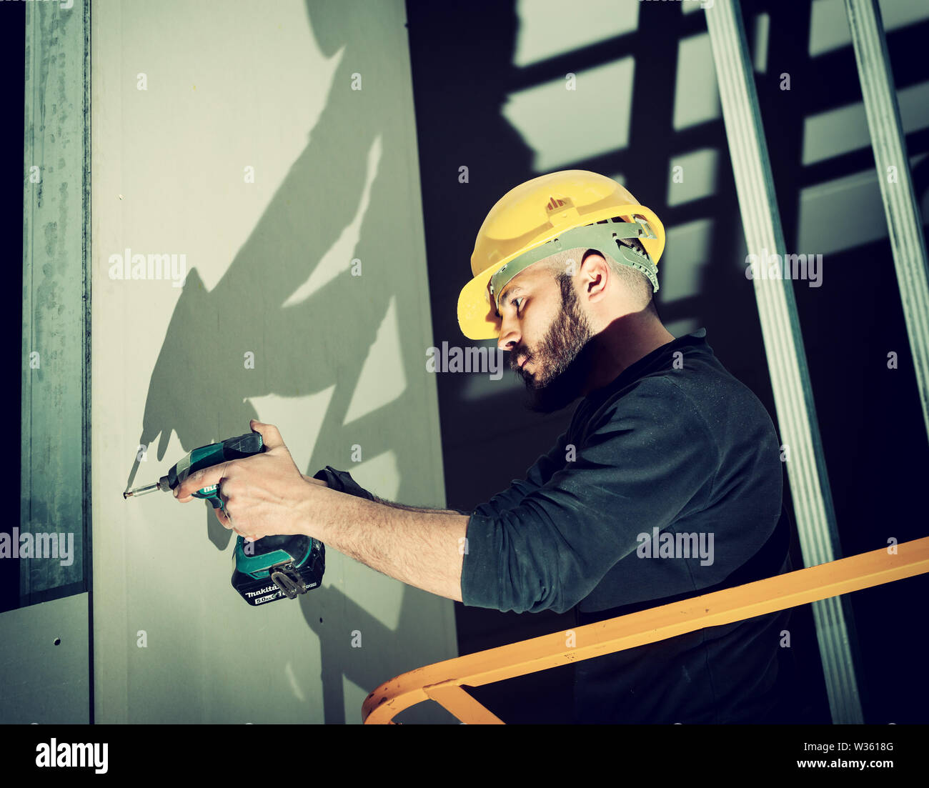 Worker at work in the construction of a plasterboard wall Stock Photo ...