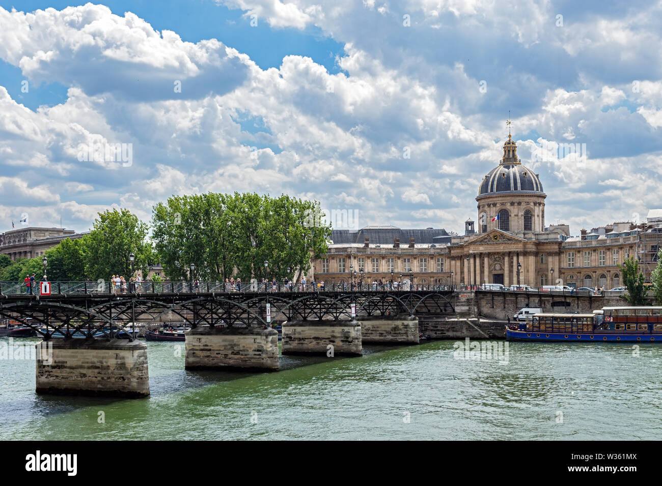 People walking on Pont des Arts bridge on the Seine river - Paris Stock ...