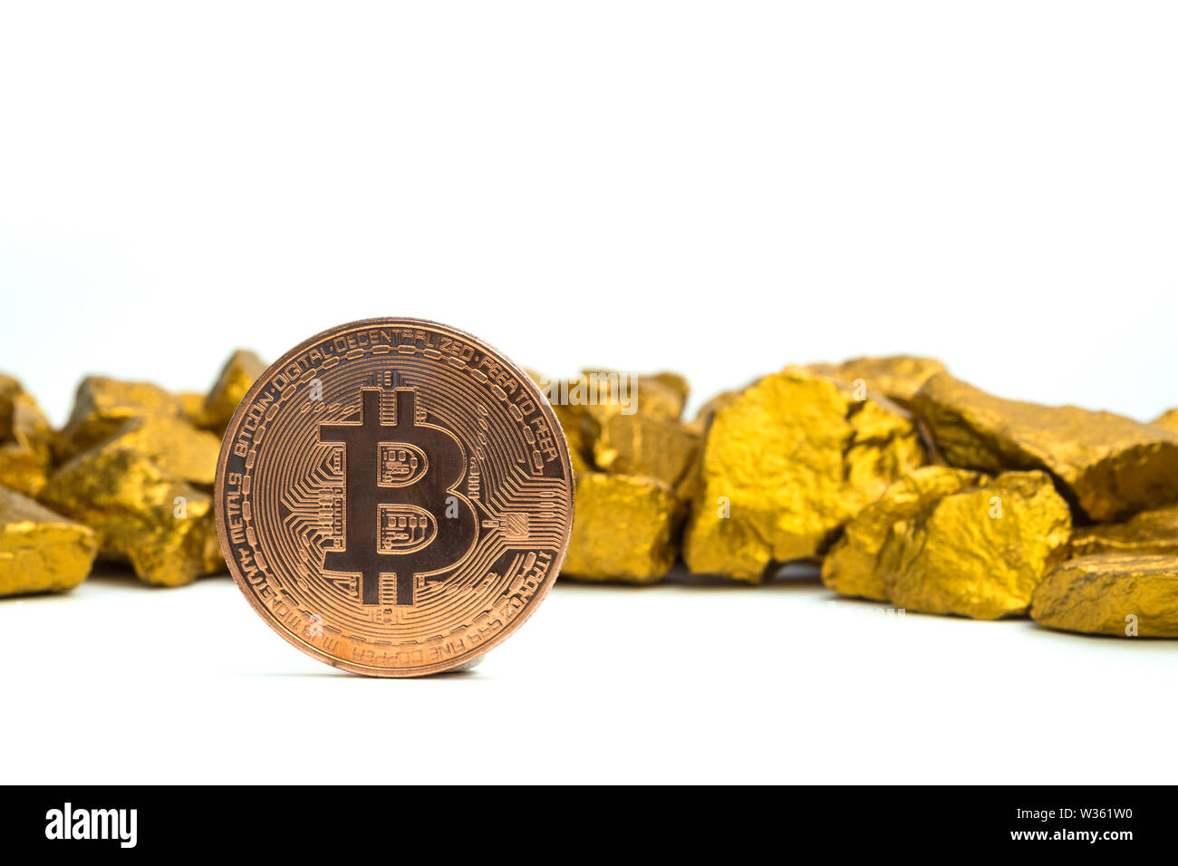Closeup of bitcoin digital currency and gold nugget or gold ore on ...
